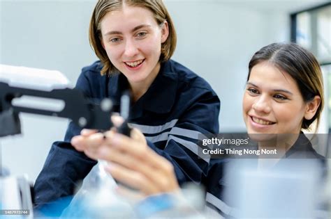 Two Female Engineers Training Write A Program Control Robot And Robot