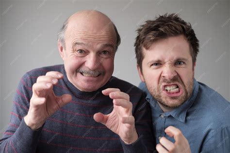 Premium Photo Angry Mature Father And Son Threating You Lookign With