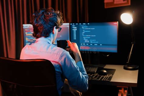 Working It Developer Concentrating Online Software At Neon Light Room Gusher Stock Photo