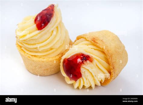 Mini Cheesecake Tartlets With Strawberry Topping Isolated On White