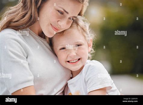 Closeup Of Loving Caucasian Mother Giving Her Adorable Daughter A Hug
