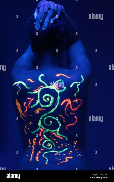 A Vertical Shot Of A Female Back With Colorful Ethnic Fluorescence