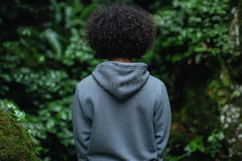 Standing In A Forest A Young Man Is Seen From Behind Stock Image