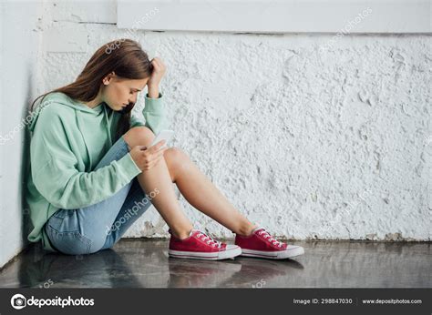 Sad Girl Sitting Against Wall Sad Girl Sitting Against Wall
