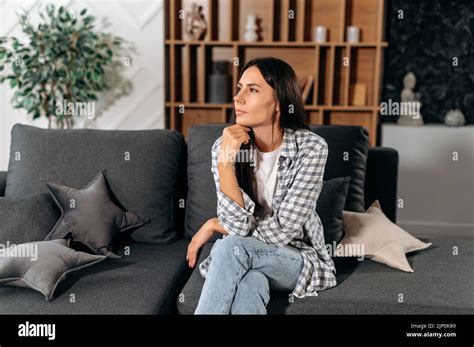 Pensive Calm Caucasian Brunette Woman Dressed In Stylish Casual Clothes