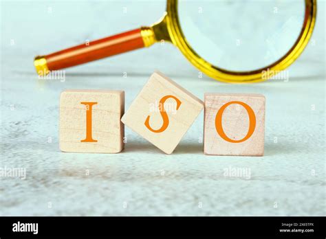 Concept Of Iso Quality Management Systems Iso Text Written On Wooden Cubes With A Magnifying