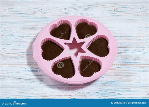 The Process Of Making Chocolate Biscuits In Bright Silicone Forms