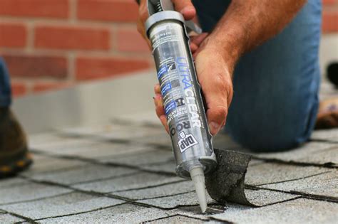 Person Applying Dap Ultra Clear Sealant To Reattach Lifted Shingle