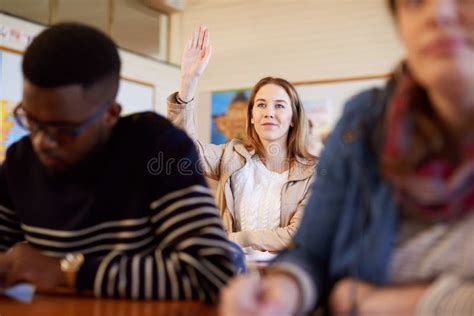 I Know The Answer To That A Young Woman Raising Her Hand In Class