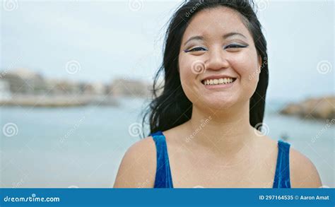 Young Chinese Woman Tourist Smiling Confident Wearing Bikini At The