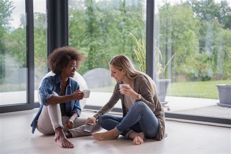 Multiethnic Women Sit On The Floor And Drinking Coffee 12094178 Stock