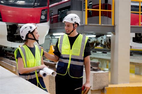 Young Caucasian Engineer Man And Woman Meeting And Checking Electric Train For Planning