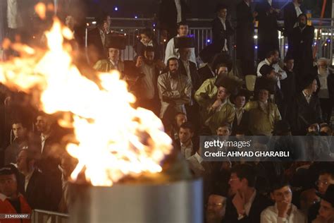 Ultra Orthodox Jewish Men Watch A Fire Burn As They Celebrate The