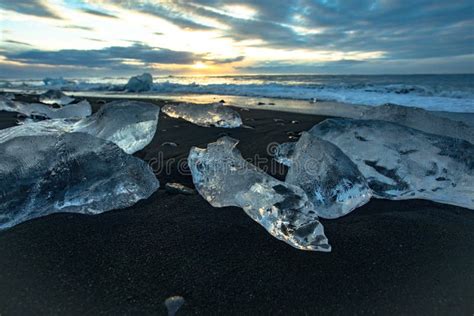 Ice Cliff With A Black Sandy Beach On Jokulsarlon Beach Diamond Beach
