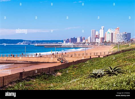 Dune Vegetation Beach And Ocean Against Blue Sky And City Skyline In