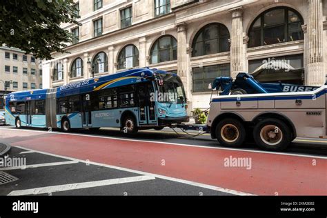 An Inoperative Electric Bus Is Pulled Along By A Massive Gas Powered