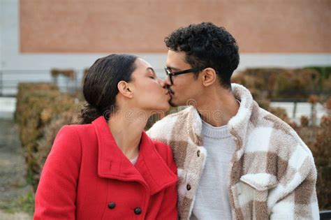 Young Multiethnic Couple Kissing on a Bench Stock Photo - Image of lovers, street: 365314716