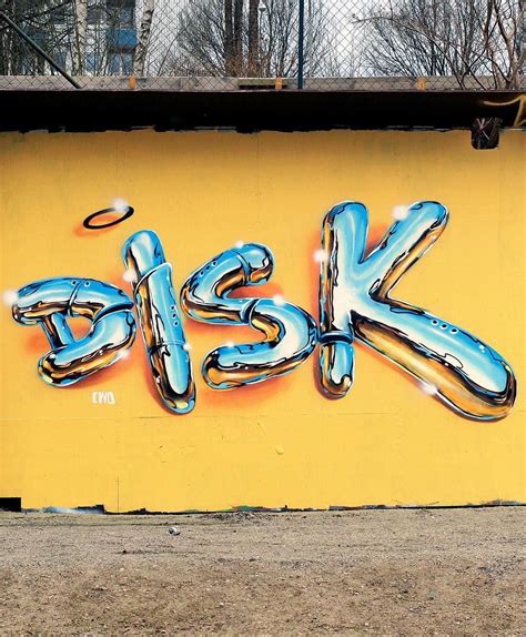 Disk Graffiti Art On Yellow Building
