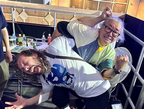 Final Fantasy Composer Nobuo Uematsu Puts Aew Wrestler Kenny Omega In Cobra Twist At Tokyo Game