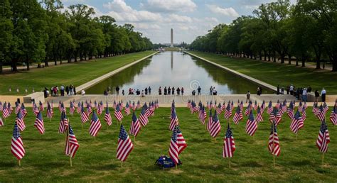 Visitors View The Washington Monument From The Reflecting Pool Surrounded By Flags On A Sunny