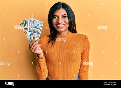 Young Latin Transsexual Transgender Woman Holding Dollars Looking