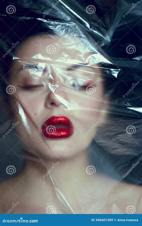 Woman With Bold Red Lips And Artistic Eye Makeup Poses With Her Face