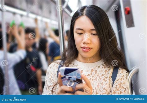 Asian Girl Using Phone On Subway Stock Image Image Of Cheerful