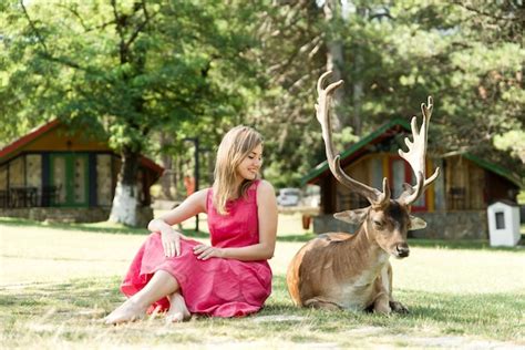 Premium Photo Girl With Wild Deer
