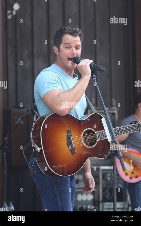 Country Music Singer Easton Corbin Is Shown Performing On Stage During A Live Concert