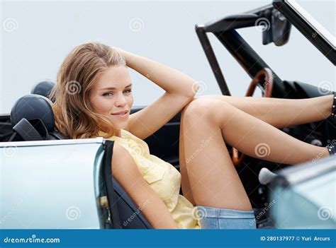 Sultry And Sensual A Gorgeous Young Woman Relaxing In A Convertible While On A Roadtrip Stock