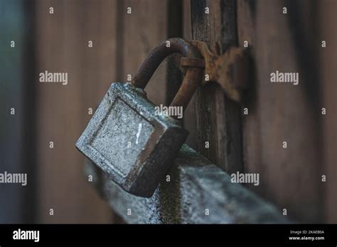 Old Rusted Padlock And Metal Fragments On Old Colorful Wooden Doors