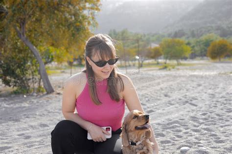 Beautiful Young Girl And Her Cocker Spaniel Dog Having Fun On The Beach