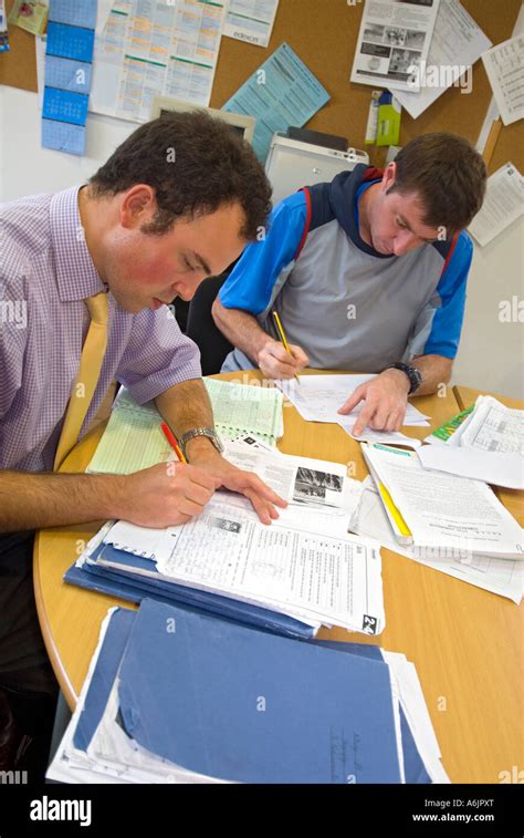 Teachers Marking Papers In School Assessing And Marking Students Teachers Marking Papers In School Assessing And Marking Students