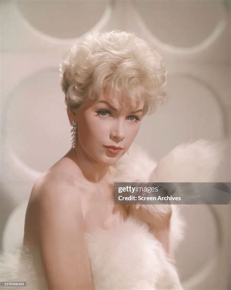 Stella Stevens Poses Bare Shouldered Holding White Fur Against Chest