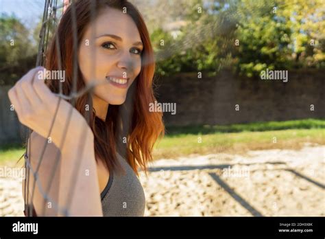 A Gorgeous Redhead Fitness Model Preparing To Play Volleyball Stock Photo Alamy