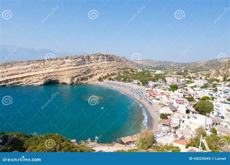 Matala Sandy Beach With Caves Near Heraklion On The Island Of Crete