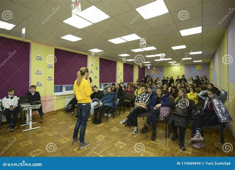 Young Girl Holding The Microphone Speaking To Students Gathered In The