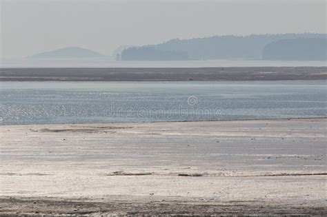 The Exposed Mud Flat Is Disappearing With The Rise Of The Tide Five