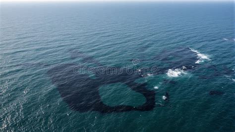 Aerial View Of Ocean Oil Spill With Dark Patches Spreading On Water