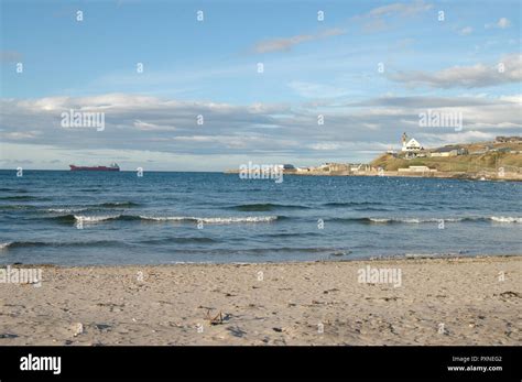 Banff Beach With The Town Of Macduff And Distinctive Church Visible Across The Bay
