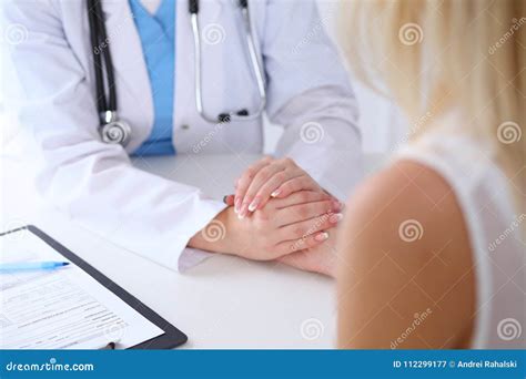 Close Up Of Doctor Hands Reassuring Her Female Patient Stock Image