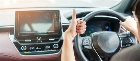 Woman Hand Thumb Up During Driving A Car On The Road Hand Controlling