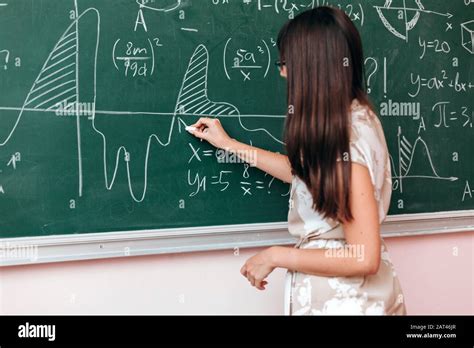 Teacher Write An Example On The Blackboard And Explain A Lesson Image
