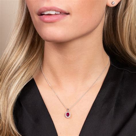 18ct White Gold Oval Cut 095ct Ruby And 031ct Diamond Halo Pendant