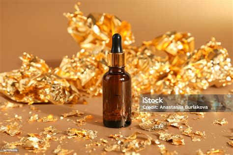 피펫이 있는 화장품 세럼 에센셜 오일 병 황금색 배경에 금색 종이 스킨케어 모이스처라이저 뷰티 제품 모형 템플릿 앞 View