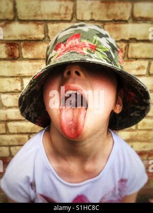 5 Year Old Girl Sticking Out Her Tongue To Catch Snow Flakes Stock