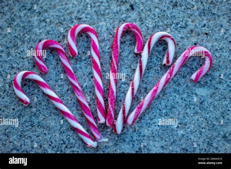 Set Of Candy Canes With Red And White Spirals For Christmas On A Stone
