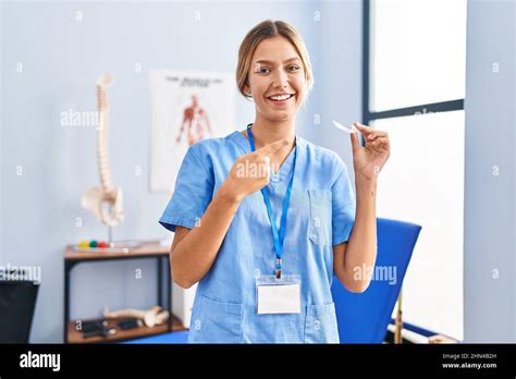 Young Blonde Woman Holding Plastic Aligner For Bruxism Smiling Happy