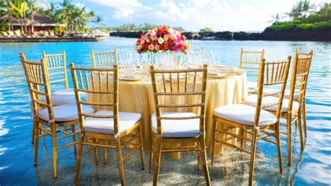 Enjoy Dinner In Paradise Elegant Setup In Blue Water With Floral