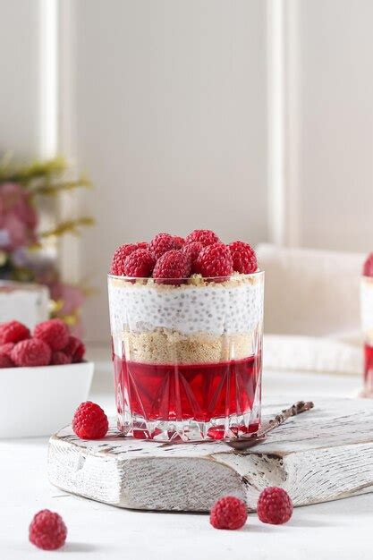 Premium Ai Image A Glass Of Raspberry Jam With A White Bowl Of